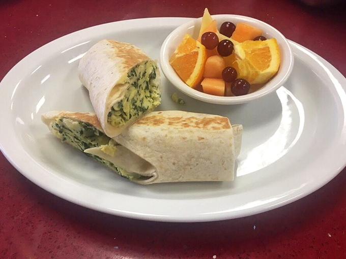 A spinach wrap that proves healthy can be delicious, paired with fresh fruit that tastes like it was picked moments ago.