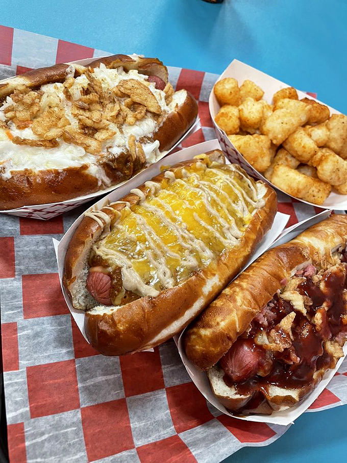 These aren't just hot dogs—they're edible works of art. The cheese-draped masterpiece in the center deserves its own exhibit.