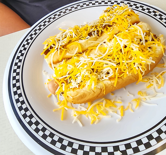 Cheese lovers, rejoice! This coney dog comes blanketed in a snowstorm of shredded cheese that would make even Wisconsin nod in approval.