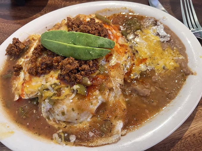 Huevos Rancheros: where eggs meet their destiny. That avocado slice isn't just a garnish&mdash;it's the emerald crown jewel of this breakfast masterpiece.