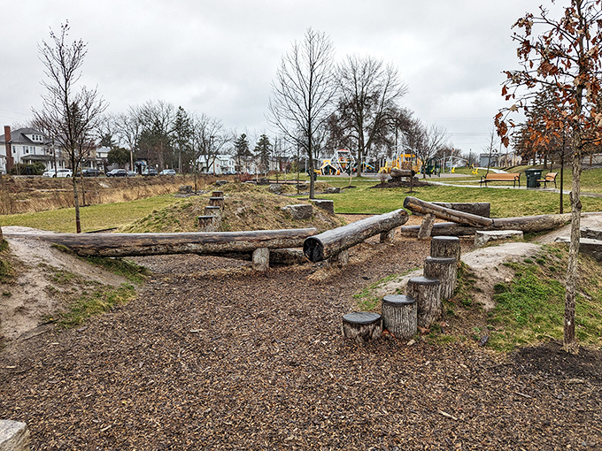 Nature meets playful design at this natural playground, where tree stumps and logs create the kind of childhood adventures that don't need charging cables.