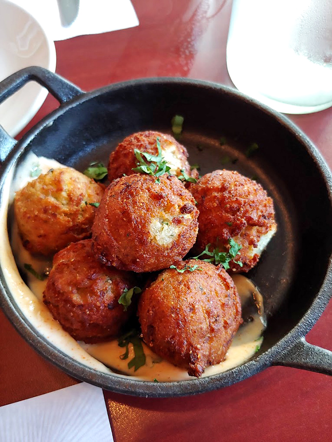 These aren't just hush puppies; they're golden orbs of joy with lump crabmeat hidden inside like buried treasure. The remoulade sauce? Pure genius.
