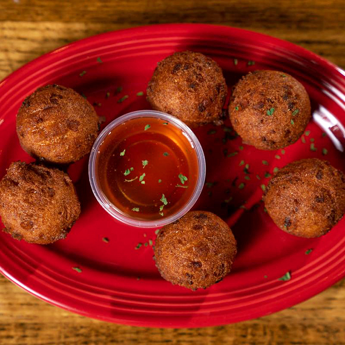 Golden-brown hush puppies that could make a Southern grandmother weep with joy. Crispy exterior, pillowy interior—the seafood sidekick of your dreams.