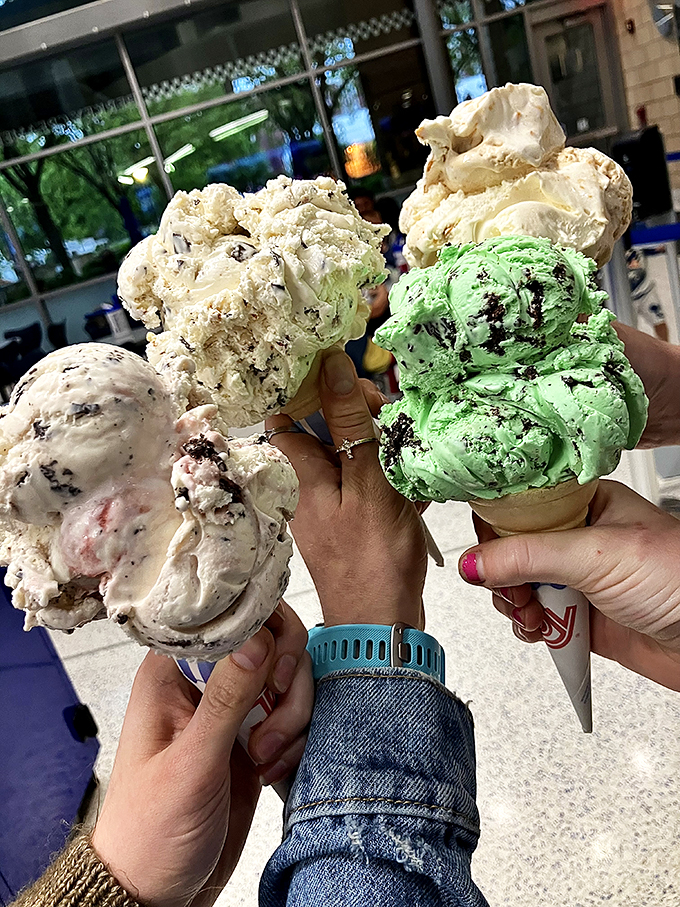 Ice cream cones raised in triumph like Olympic torches&mdash;mint chocolate chip and cookies & cream competing for gold medal status.