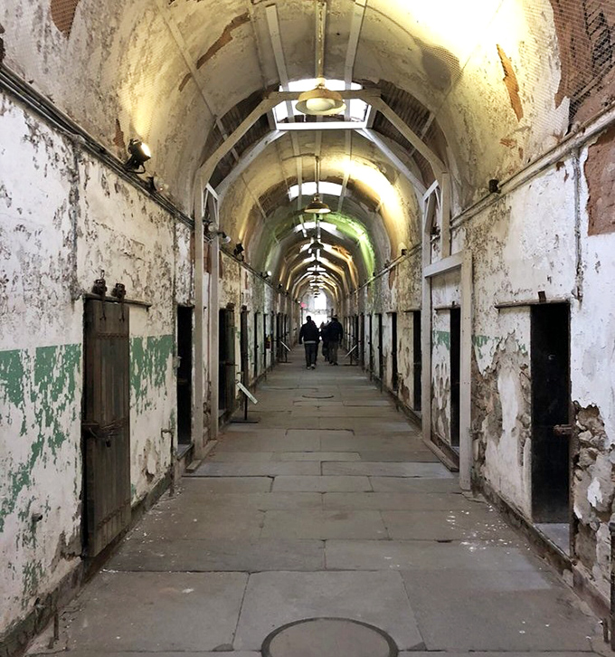Time stands still in these haunting corridors. The mint-green paint peeling away reveals layers of history like rings in a very troubled tree.