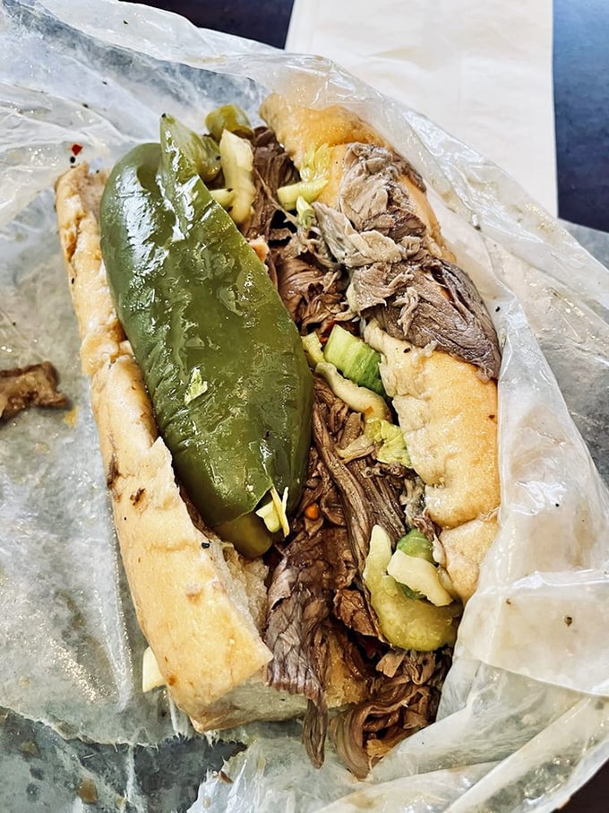 Behold the star of the show: thinly sliced beef, perfectly seasoned, piled high on that magical bread with sweet peppers. Poetry in sandwich form.