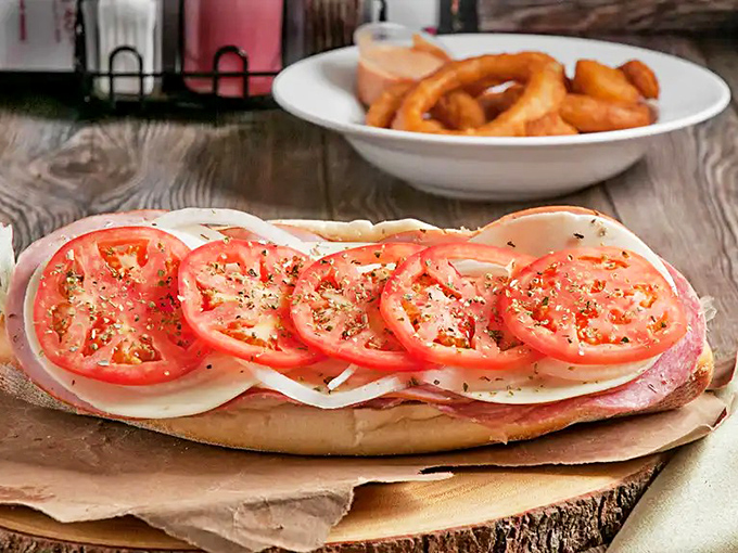 Behold the architectural marvel that is Pudge's Italian hoagie. Those tomatoes aren't just toppings—they're jewels in a deli crown.