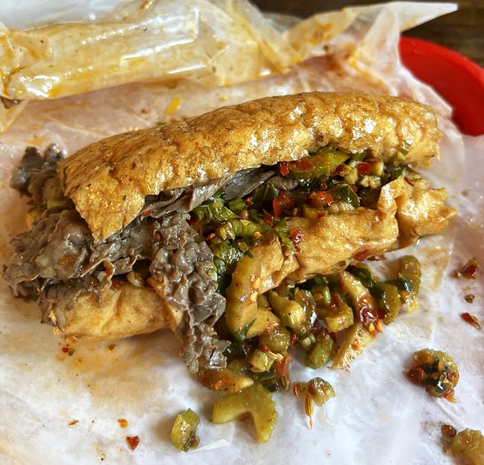 Behold the Italian beef in its natural habitat &ndash; paper-wrapped, giardiniera-topped, and gloriously messy. This isn't just a sandwich; it's Chicago's soul between bread.