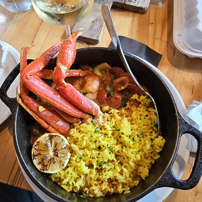Behold the jambalaya that launches a thousand road trips - served in a cast iron skillet like nature intended. 