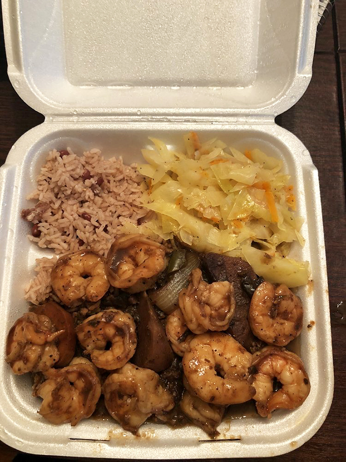 The star of the show: jerk shrimp nestled against rice and peas with cabbage&mdash;a styrofoam container of pure Caribbean joy.
