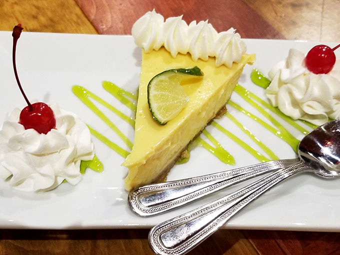 Key lime perfection on a plate. This slice of Florida sunshine features the ideal balance of tart and sweet, topped with a lime wheel sentinel.