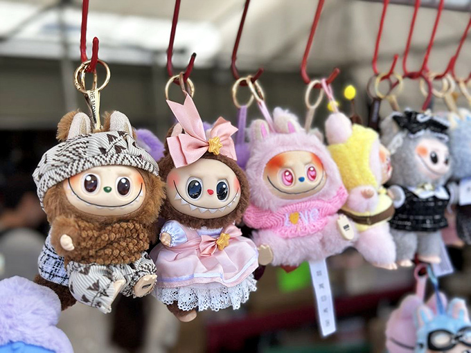Adorable collectible toys dangle like tiny ambassadors of joy, proving that happiness comes in all sizes and styles.