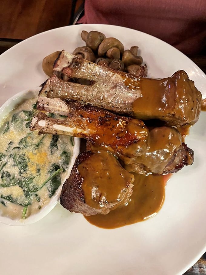 These lamb chops aren't just dinner, they're a masterpiece&mdash;perfectly frenched bones rising from a pool of savory sauce with creamed spinach playing the delicious supporting role.