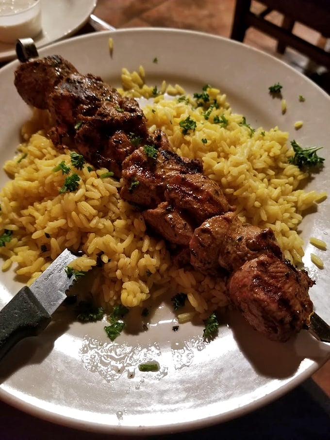 The legendary lamb kabob arrives like royalty on a bed of saffron rice. This isn't just meat on a stick&mdash;it's edible poetry.