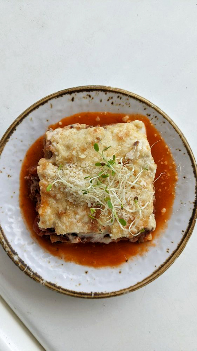 The legendary lamb lasagna arrives like royalty on its throne of sauce. Those tender layers have launched a thousand pilgrimages from across Virginia.