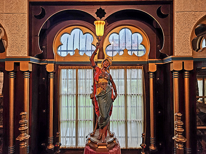 This elegant lamp figure seems to say, "Yes, I'm holding this light, and yes, I'm doing it with more style than your average floor lamp."