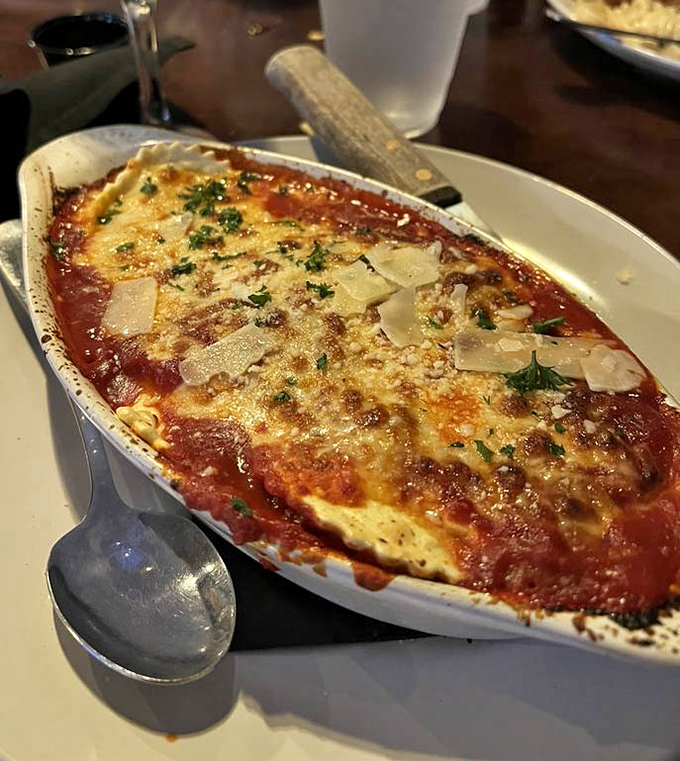 Behold the lasagna that launched a thousand food pilgrimages. That golden, bubbling cheese layer isn't just a topping&mdash;it's a promise of the happiness waiting beneath.