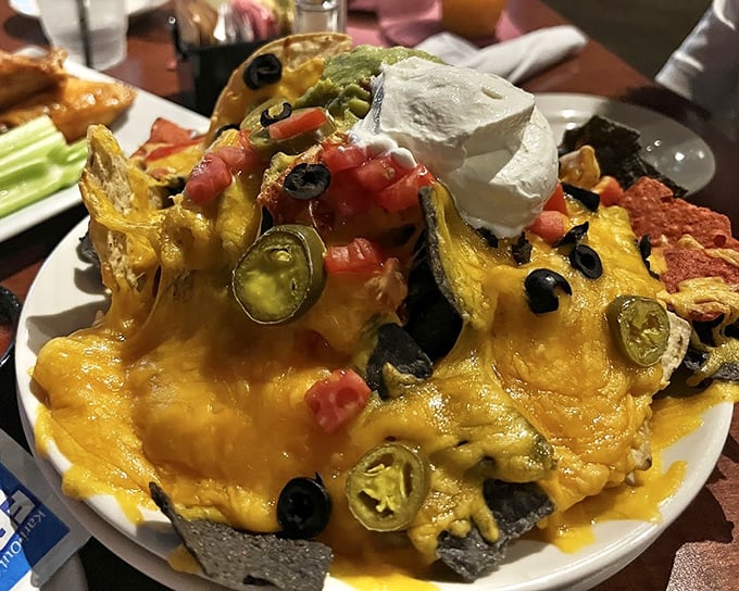 Behold the nacho mothership! This gravity-defying mountain of cheese, jalape&ntilde;os, and perfectly distributed toppings makes sharing feel like a crime.