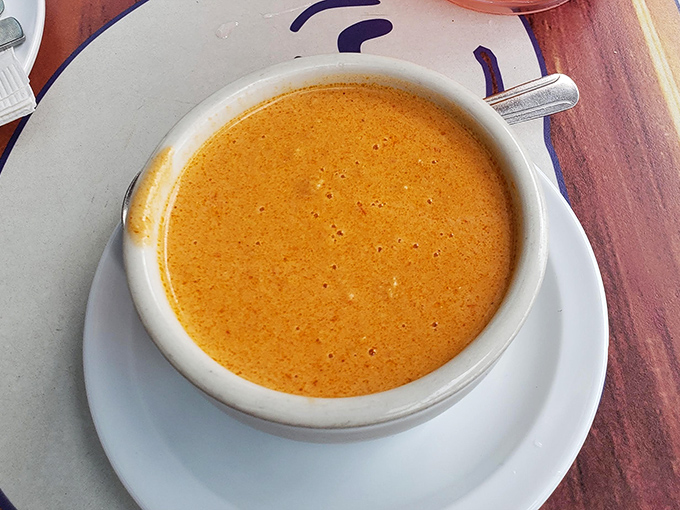 Liquid gold in a bowl. The legendary lobster bisque arrives unassuming, but one spoonful explains why people drive hours just for this creamy ocean elixir.