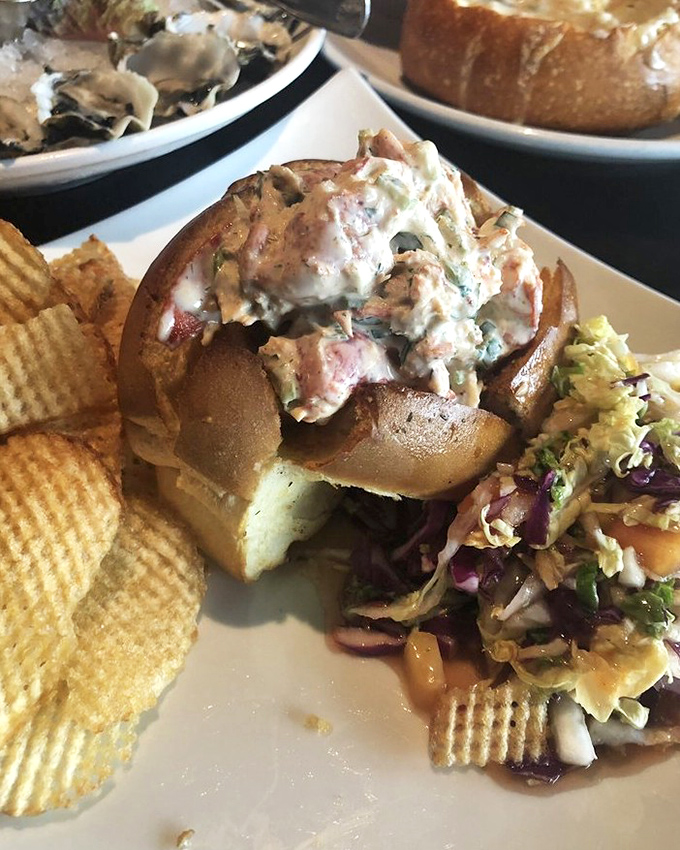 This isn't just a sandwich; it's a celebration of the sea &mdash; a lobster roll overflowing with tender lobster salad on toasted bread, served with house-made chips that crunch like autumn leaves.