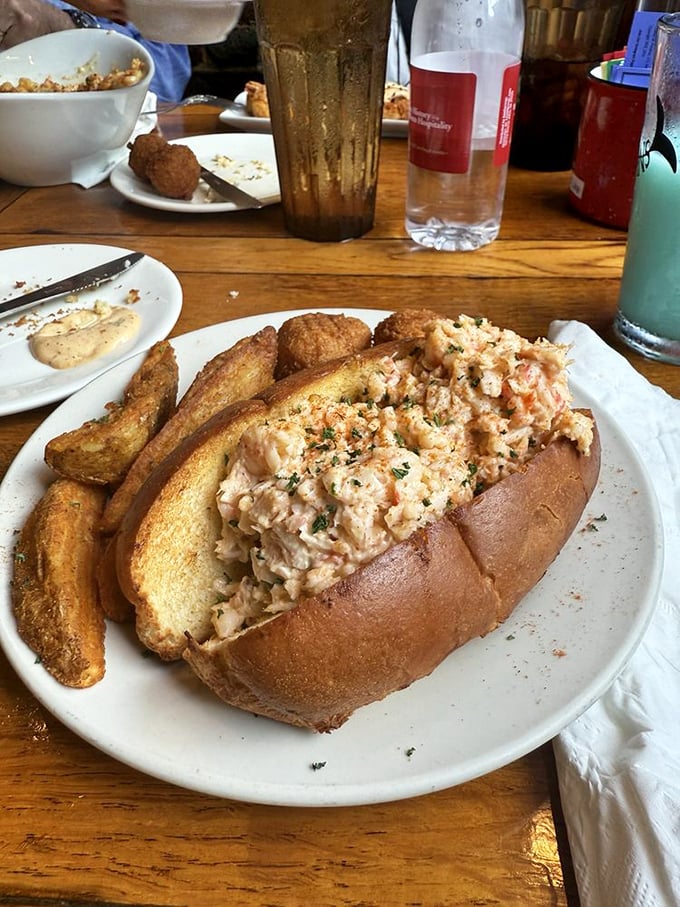 This isn't just a lobster roll&mdash;it's edible poetry. Generous chunks of sweet meat nestled in a perfectly toasted bun with golden potato wedges standing guard.