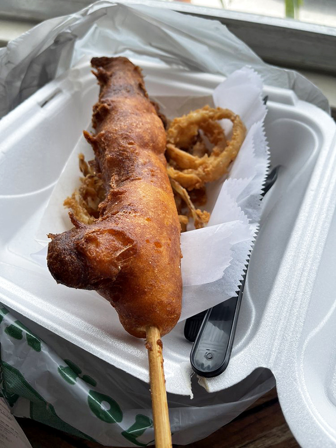 The lobster corn dog arrives on a stick, proving that fancy food can still be fun food.