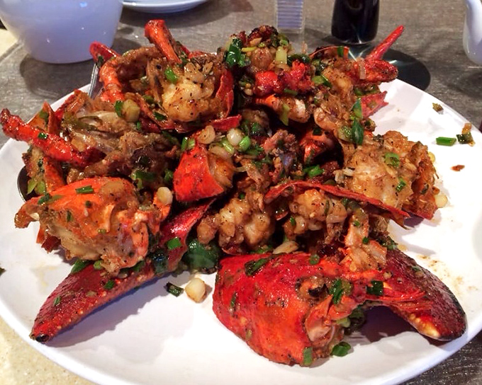 The legendary House Special Lobster arrives like a crimson crown jewel, glistening with garlic, scallions, and just enough spice to wake up your taste buds.