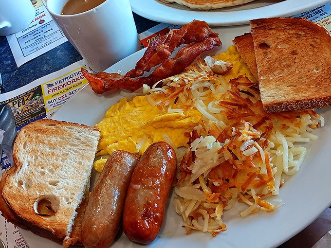 Breakfast perfection on a plate&mdash;crispy hash browns, golden toast, perfectly cooked eggs, and sausage links that snap with each bite. Morning glory, indeed!