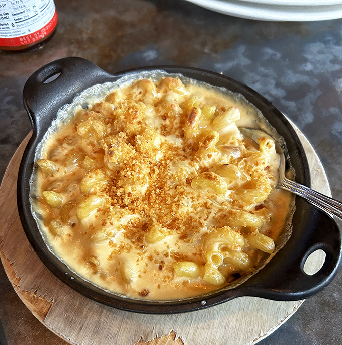 This isn't just mac and cheese—it's a bubbling cauldron of cheesy perfection that makes adulthood worthwhile. Diet starts tomorrow.