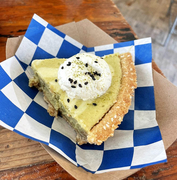 This key lime pie topped with whipped cream isn't just dessert; it's a vacation for your taste buds without the hassle of TSA screening.