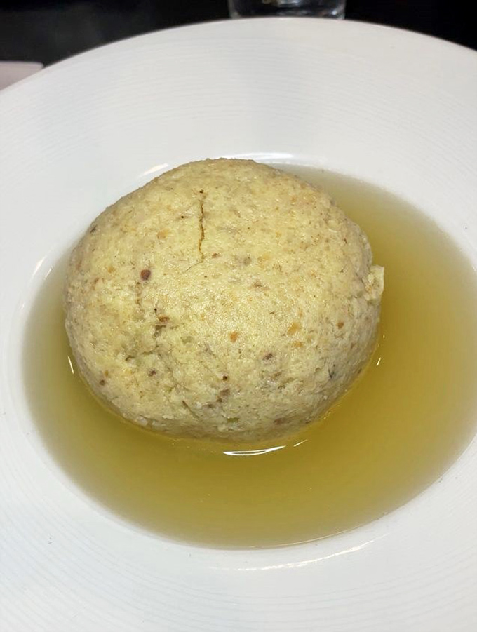 Behold, the star of the show&mdash;a perfect matzo ball floating majestically in golden broth. Jewish penicillin at its finest, no prescription needed.
