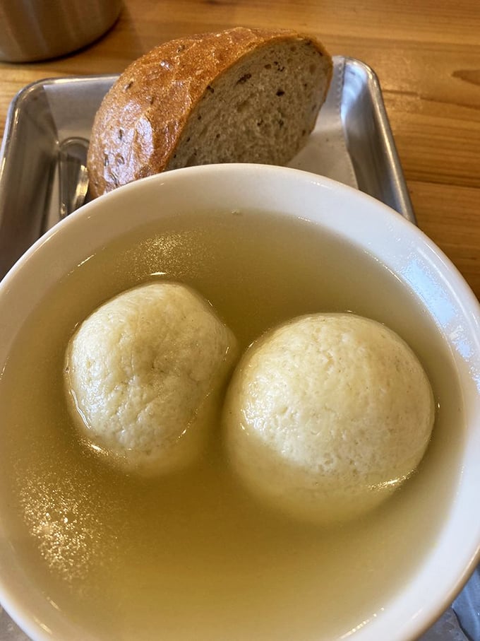 Two matzo balls floating in golden glory – this is what comfort looks like in a bowl.