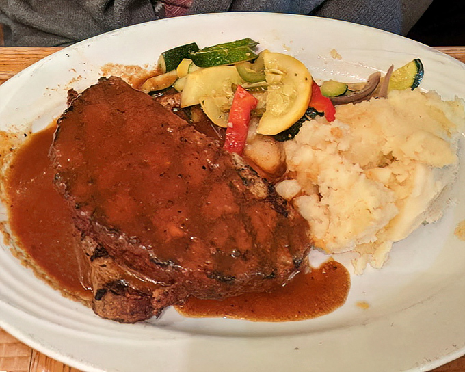 The star of the show: meatloaf that doesn't just sit on the plate—it commands respect. That gravy deserves its own fan club.