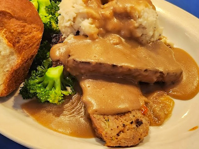 This isn't just meatloaf; it's a masterclass in comfort. Bathed in rich gravy and served with fluffy mashed potatoes, it's what food dreams are made of.