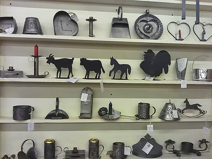 Metal farm implements and folk art silhouettes line these shelves&mdash;practical tools from yesterday that have become today's rustic decor statements.