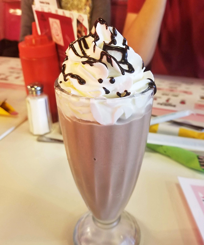 This isn't just a milkshake &ndash; it's architecture in a glass, with whipped cream and chocolate drizzle creating a skyline worth demolishing.