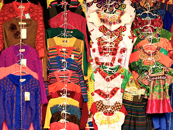 Rainbow rows of traditional garments showcase the beautiful diversity that makes every shopping trip a cultural adventure.