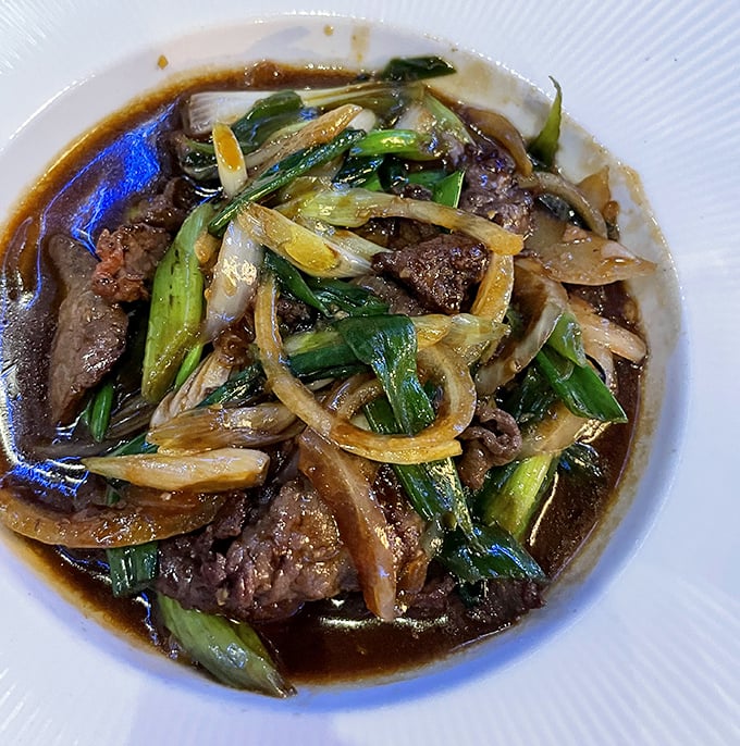 Tender slices of beef dance with green onions in a savory sauce&mdash;proof that sometimes the simplest dishes deliver the most profound flavors.
