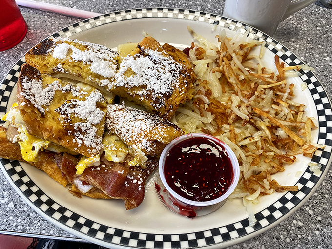 The legendary Monte Cristo in its powdered sugar glory. That little cup of raspberry jam isn't optional&mdash;it's the co-star in this sweet-savory romance.