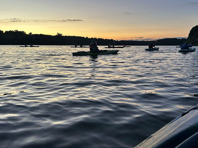 Twilight transforms Marsh Creek into a magical realm where kayakers become silhouettes against nature's most spectacular light show.