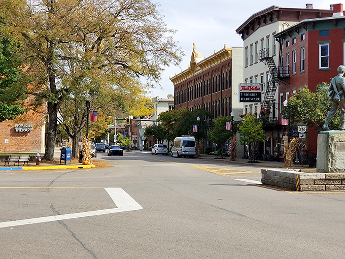 Fall colors frame McConnelsville's historic downtown, where the statue seems to be thinking, "Now this is what retirement should look like."