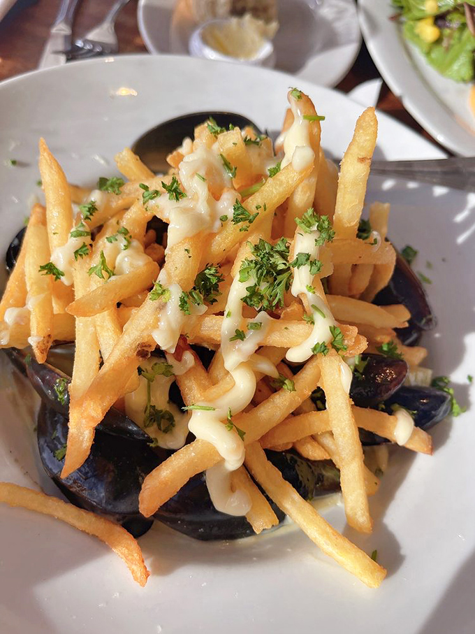 These aren't just fries with mussels&mdash;they're a culinary high-wire act where crispy potatoes meet oceanic depth, all tied together with herb-flecked sauce.