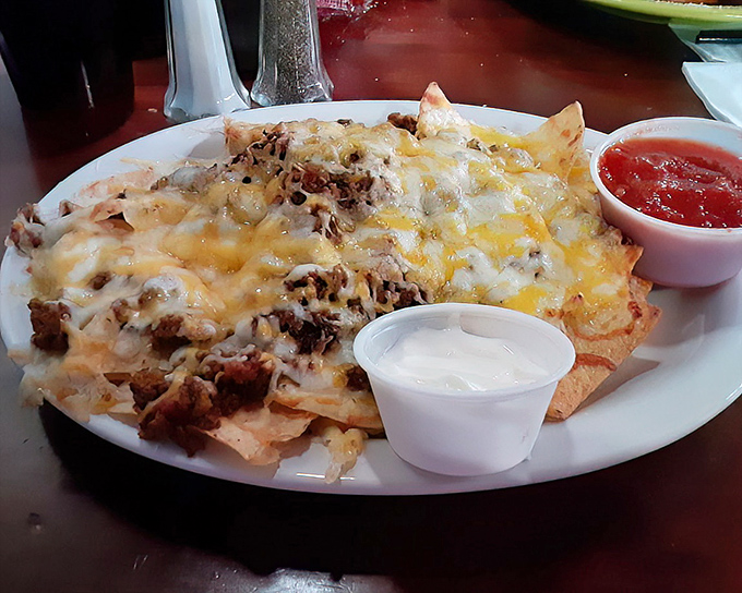 Behold the nachos that launched a thousand road trips! Perfectly distributed toppings ensure every chip gets its fair share of melty cheese and seasoned beef.