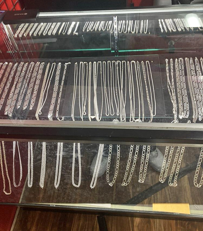 Silver chains gleaming under display lights like metallic rivers, each waiting to become someone's everyday signature piece.