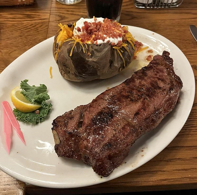 A perfectly seared New York Strip alongside a loaded baked potato—proof that sometimes the classics become classics for a very good reason.
