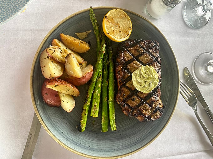 The New York steak arrives like a perfectly grilled love letter to carnivores, with that herb butter slowly melting into a pool of "I'll diet tomorrow" bliss.