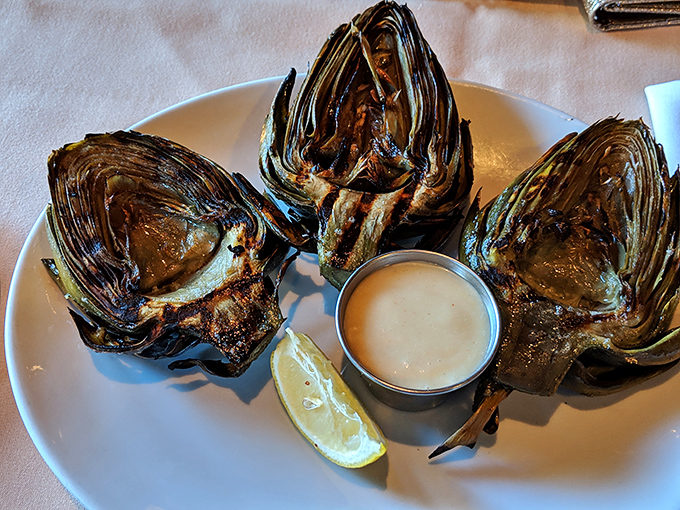 Behold the star of the show! These oak-grilled artichokes arrive with perfect char marks, tender hearts, and a dipping sauce that'll make you consider drinking it straight.