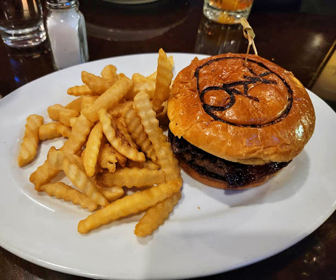 The signature Oak burger arrives like a work of art&mdash;branded bun, perfectly charred patty, and golden fries that somehow maintain their crispiness until the very last bite.