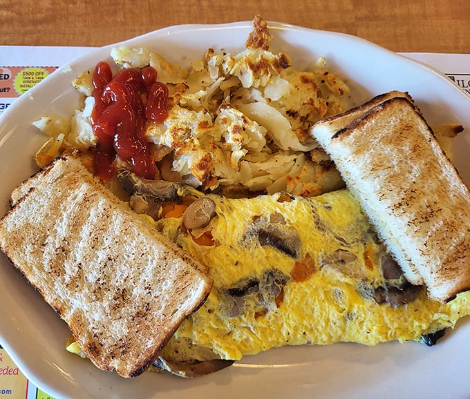 Behold the star attraction: a mushroom and veggie omelet that's fluffy enough to make clouds jealous, served with perfectly golden toast.