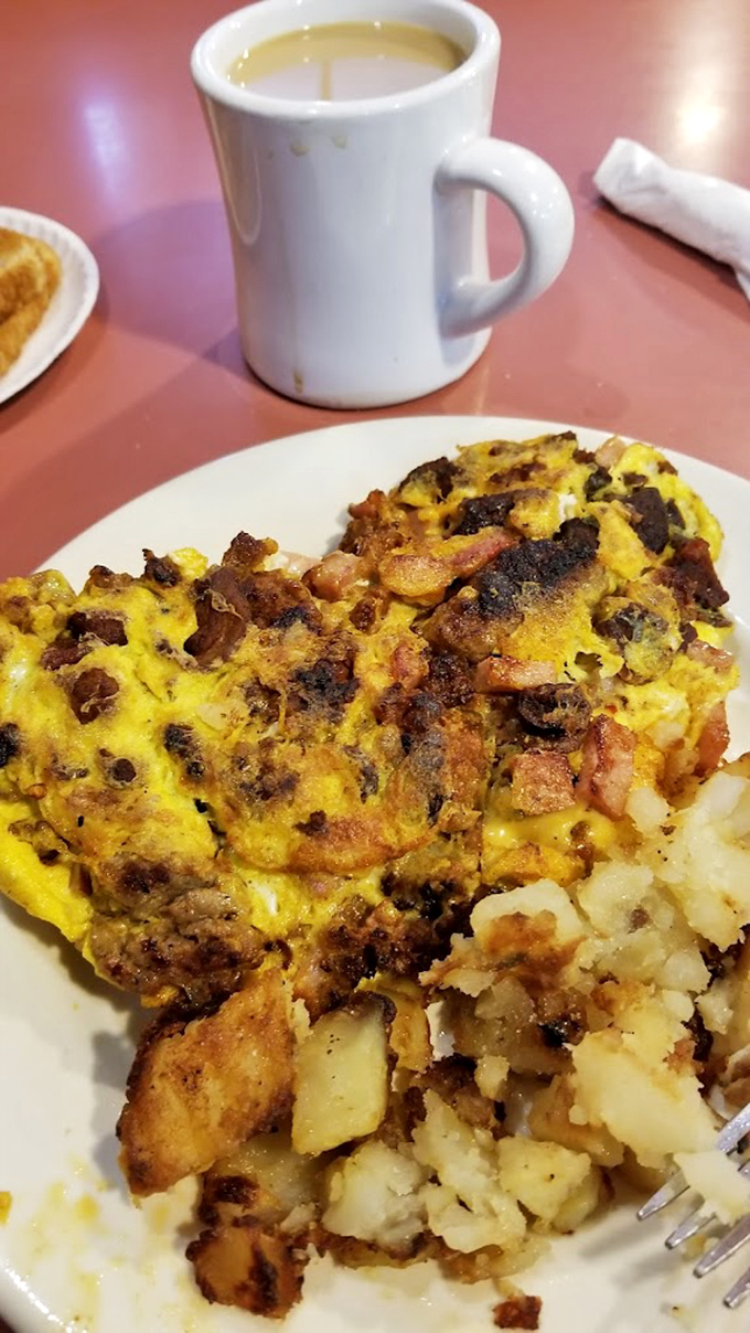Behold the Western omelet in all its glory - ham, cheese, peppers and onions folded with origami-level precision and artistry.